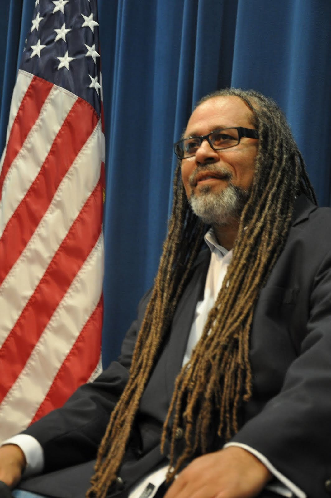 Hari Jones seated with an American flag